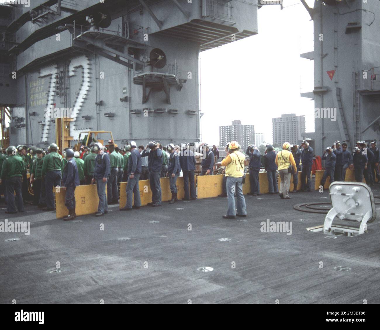 Flight deck crew members on the nuclear-powered aircraft carrier USS ...