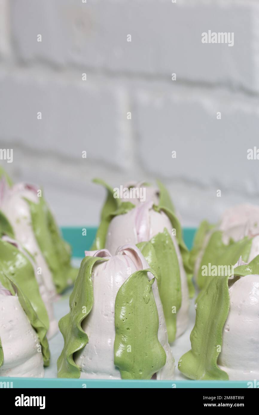 Homemade zephyr tulips dry on a tray. On a white background. Close-up ...