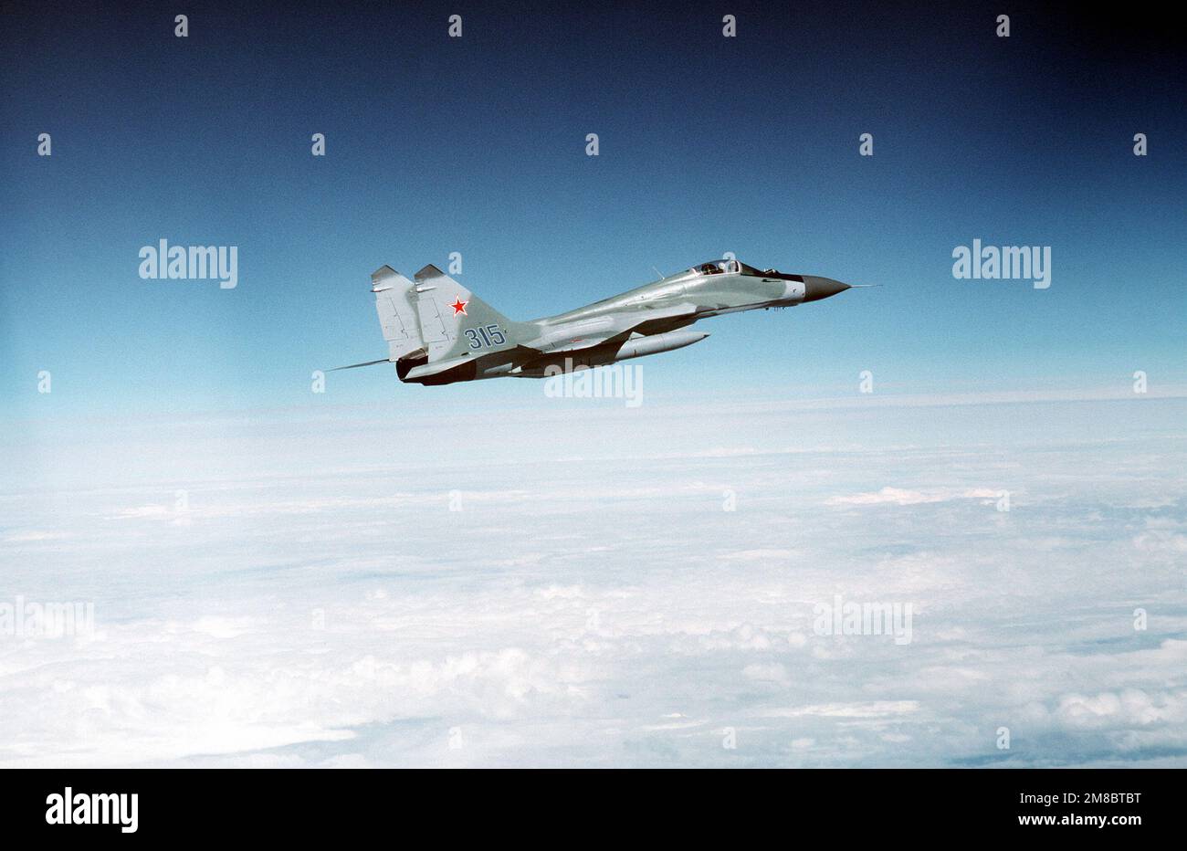 An air-to-air right side view of a Soviet MiG-29 aircraft en route to ...