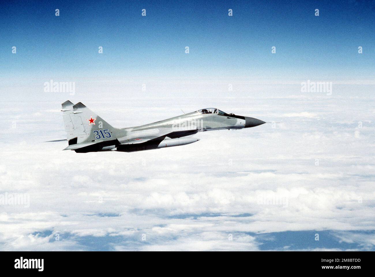 An air-to-air right side view of a Soviet MiG-29 aircraft en route to ...