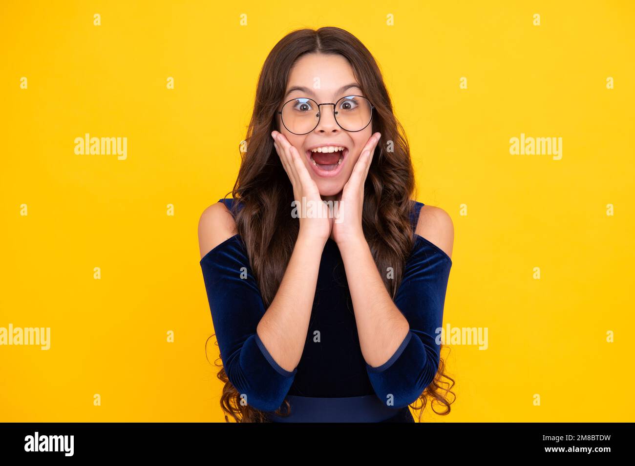 Shocked teenager child with amazed look on yellow background, amazement ...