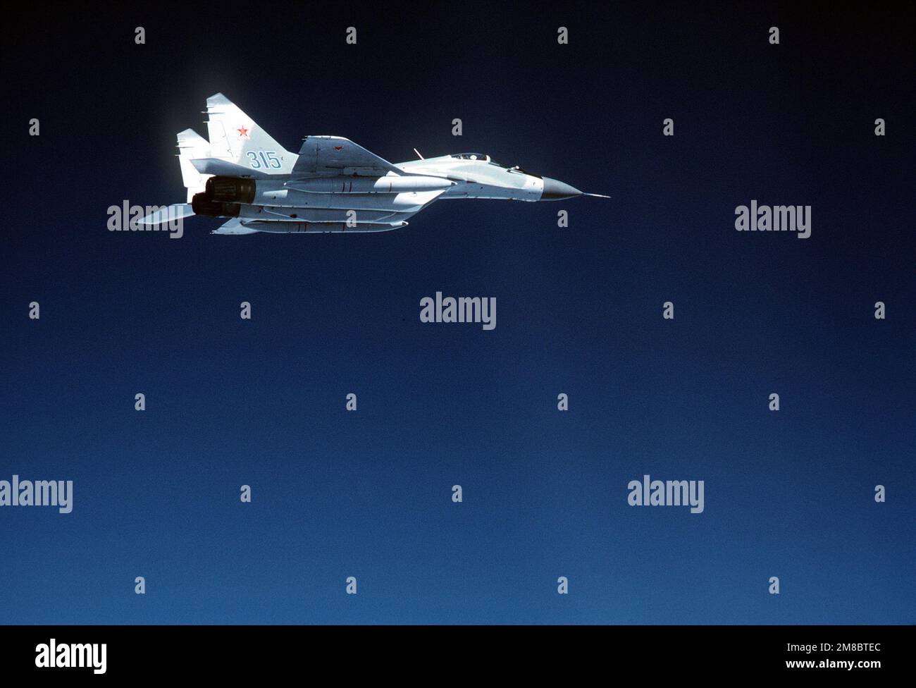 An air-to-air right side view of a Soviet MiG-29 aircraft en route to ...