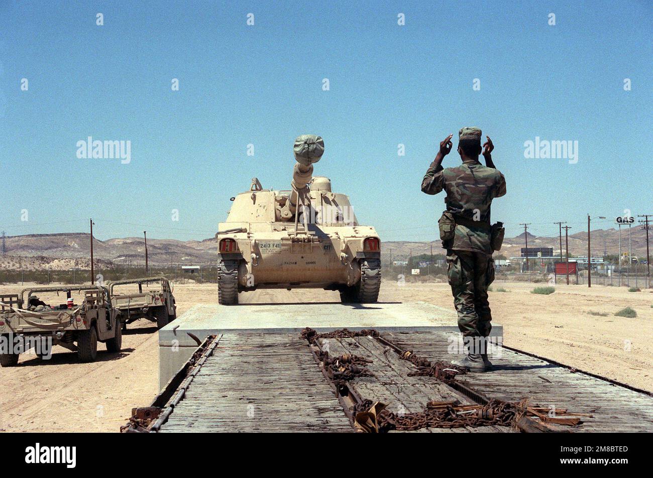 A soldier of the 24th Infantry Division (Mechanized) guides an M-109 ...