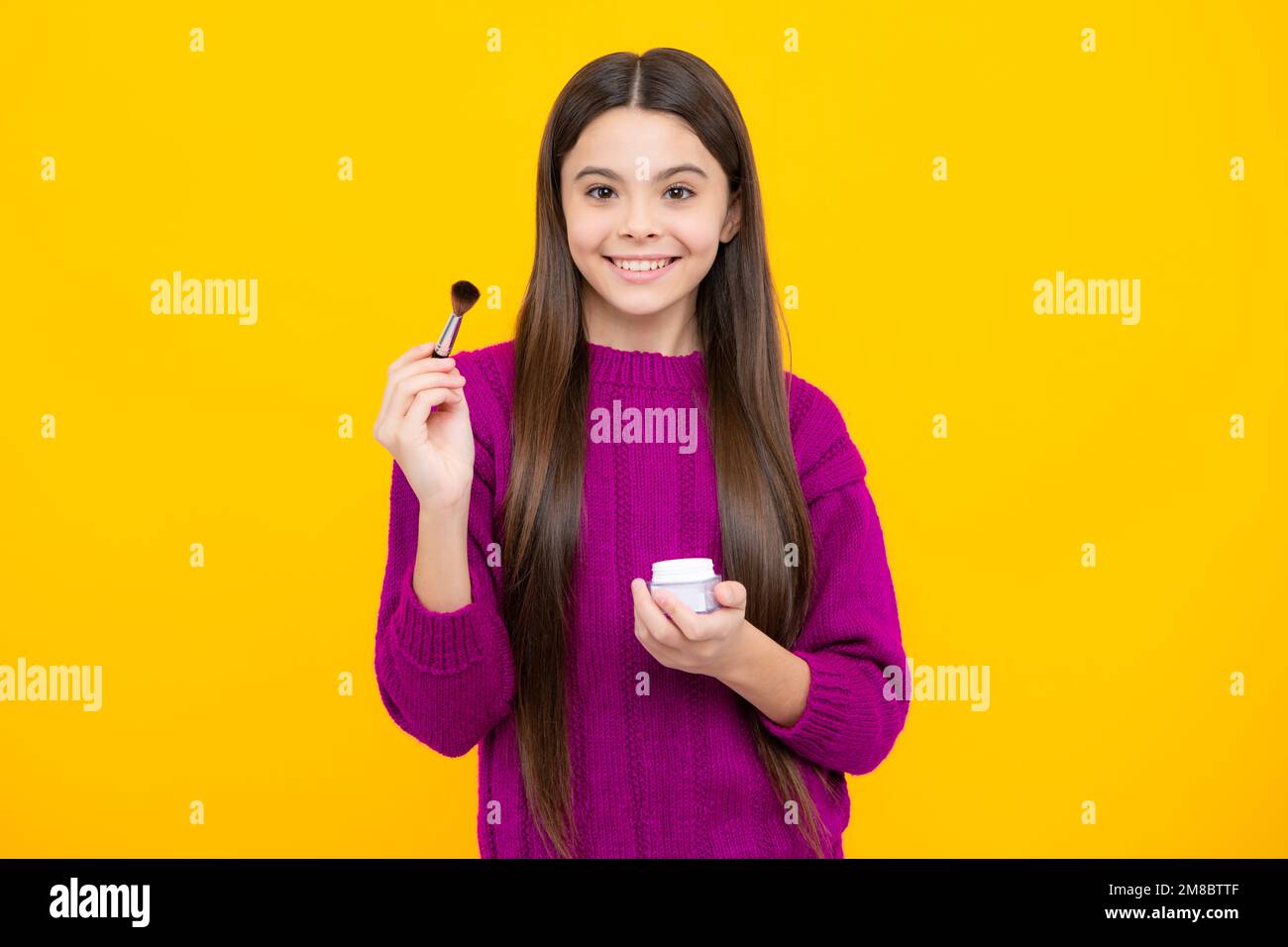 Kids make up products. Makeup teen child artist apply face powder with ...