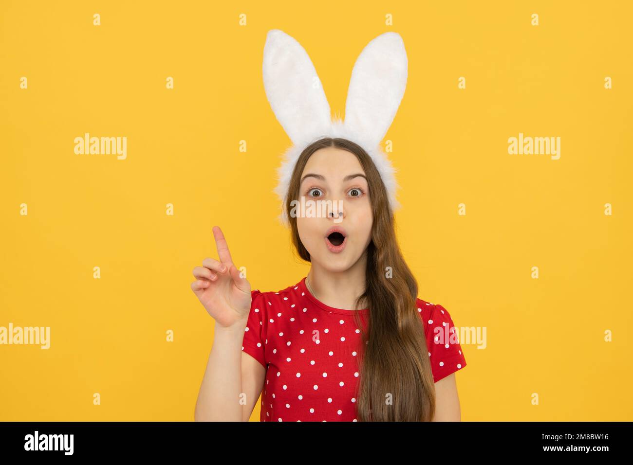 Teen Girl Wearing Bunny Ears Isolated At Yellow Background Amazed