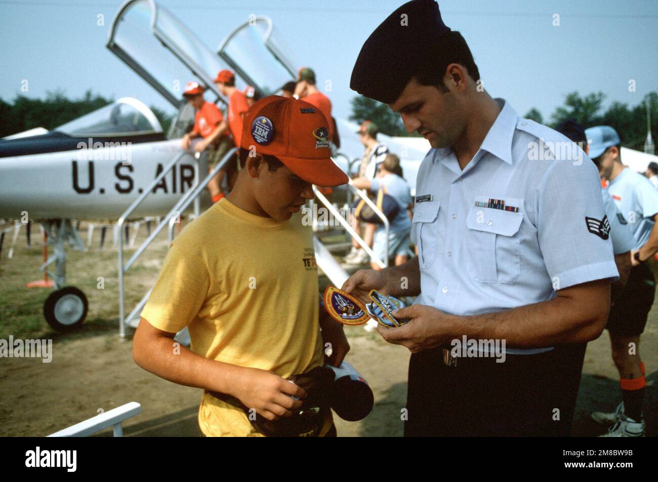 Sergeant Pete Conrad watches as Boy Scout Owen Bishop trade patches ...