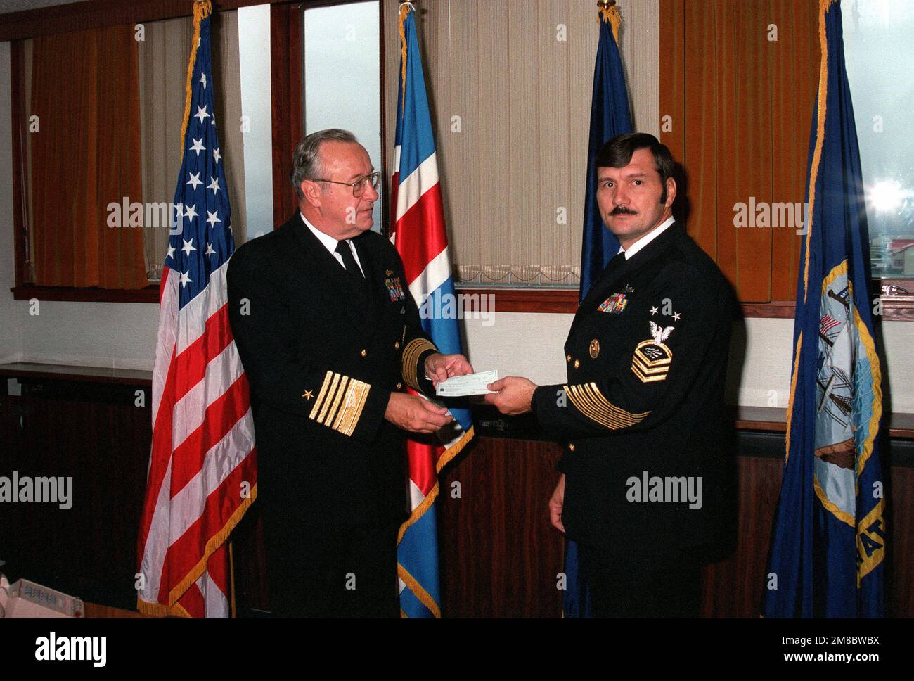 A master chief petty officer presents a contribution to CHIEF of Naval ...