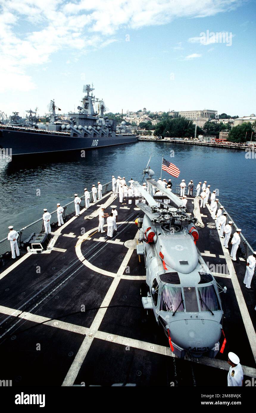 Rotors folded, an SH-60B Seahawk helicopter sits on the deck of the ...