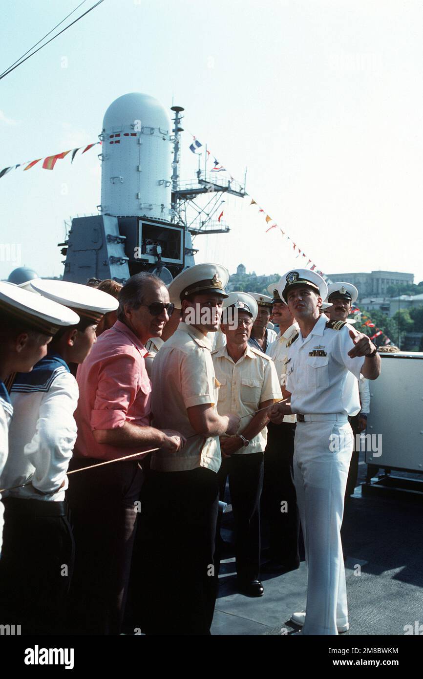 With the Phalanx Close In Weapons System (CIWS) looming behind them, an ...