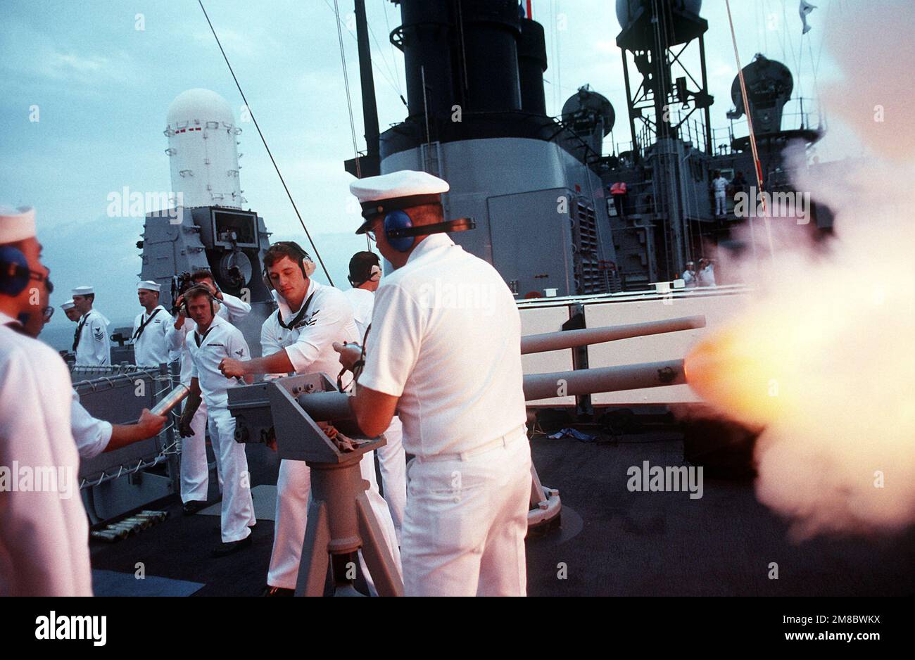 A saluting gun is fired from the deck of the Aegis guided missile ...