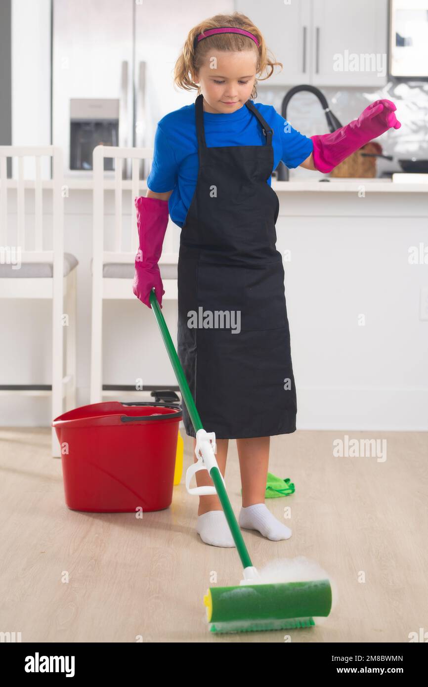 Child use duster and gloves for cleaning. Funny child mopping house ...