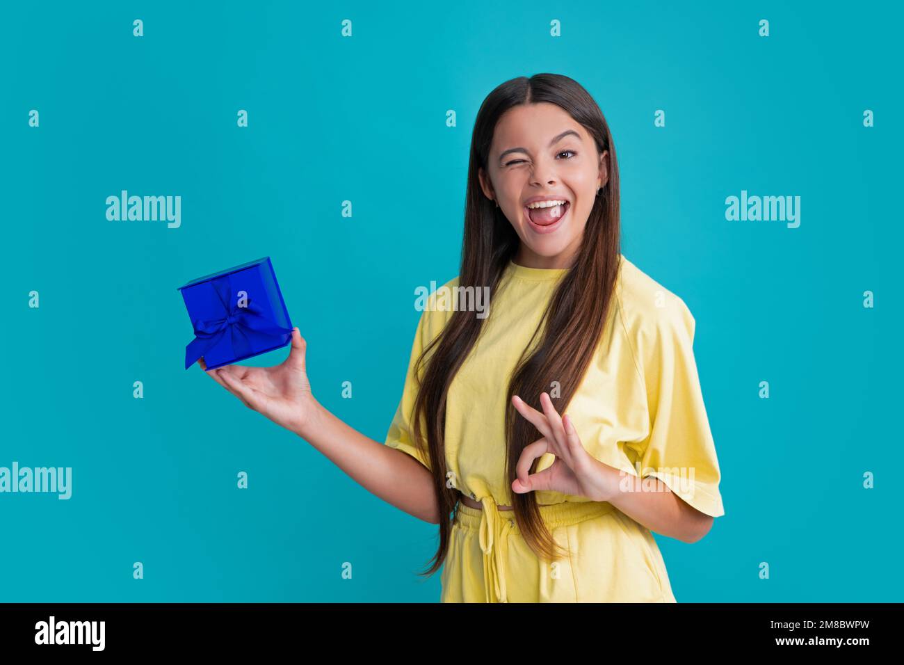 Funny face. Emotional teenager child hold gift on birthday. Funny kid ...