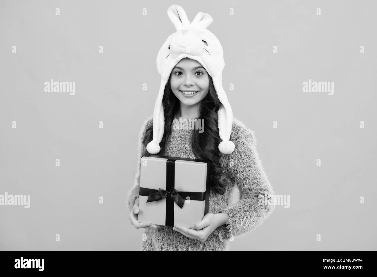 Child with gift present box on isolated background. Presents for ...