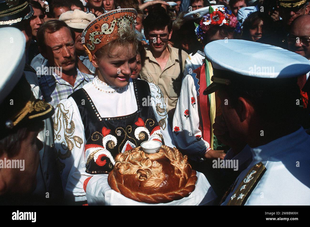 A young Ukranian woman in traditional costume presents Vice Admiral R ...
