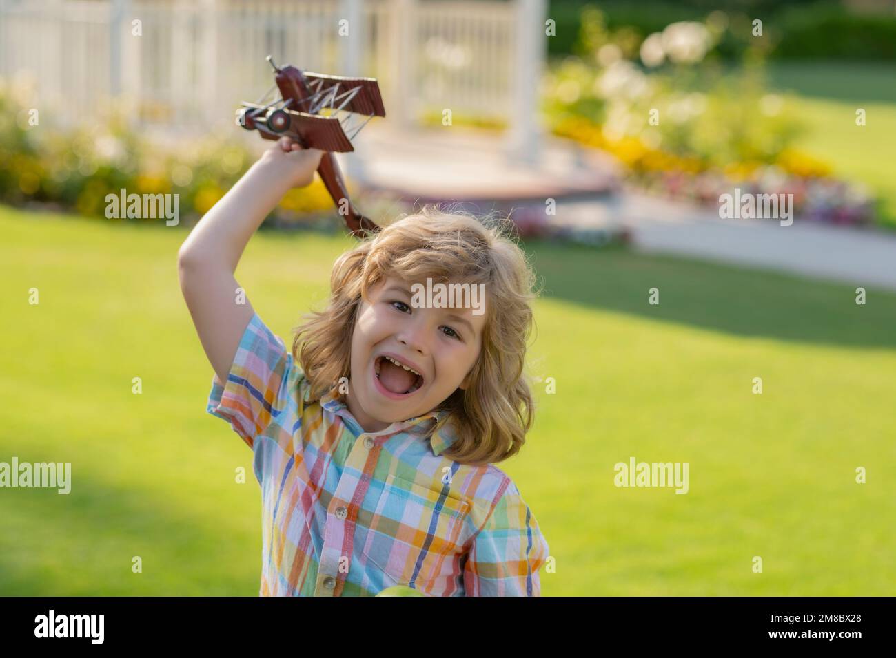Happy childhood. Dream of flying. Little children with toy airplane in ...