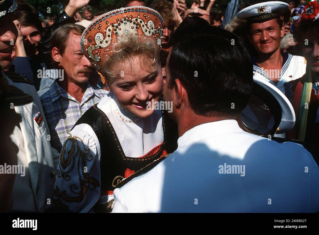 A young Ukrainian woman gets a kiss on the cheek from Vice Admiral R ...