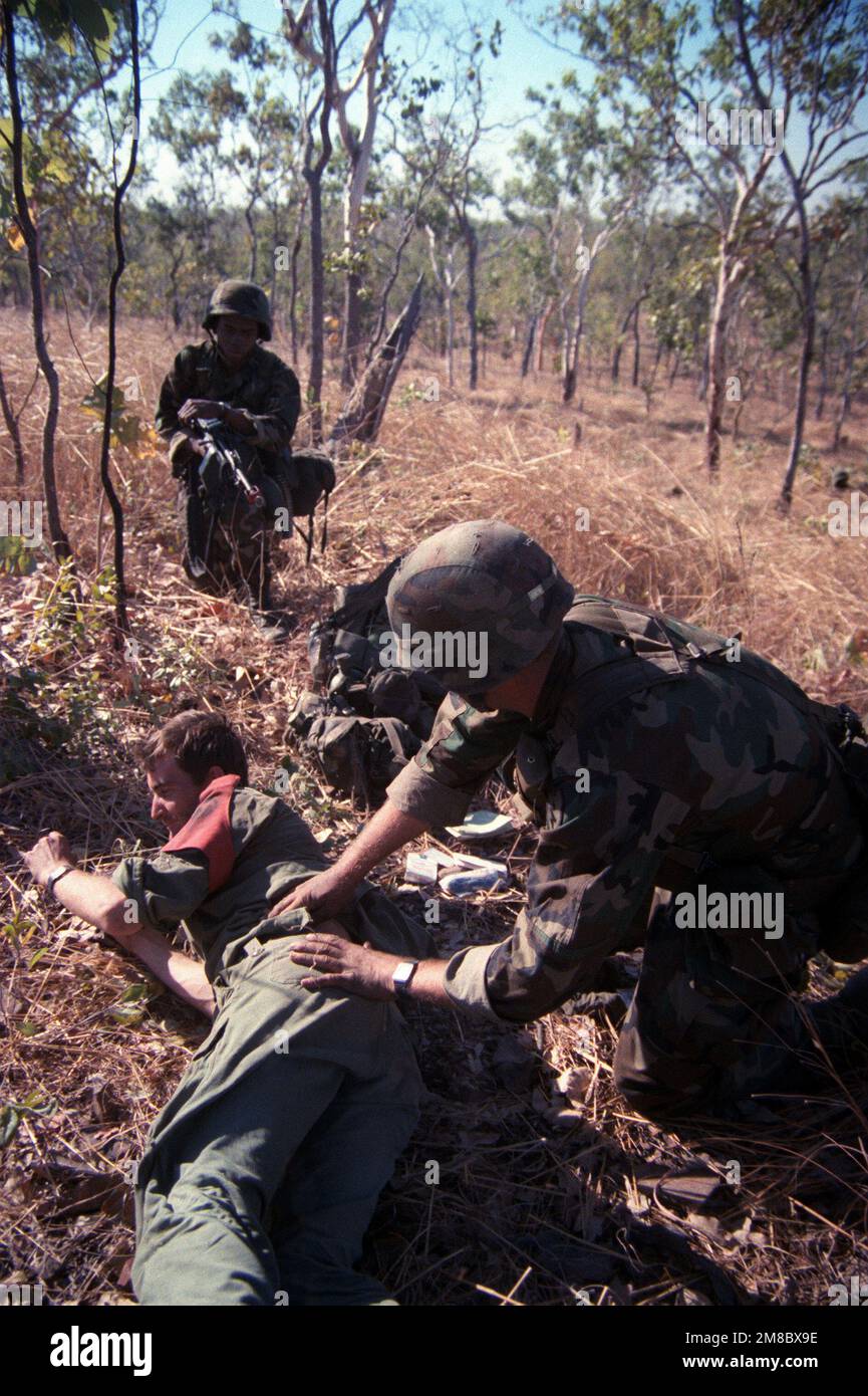 A medic from 4th Bn., 87th Inf., 25th Inf. Div. (Light), tends to a ...