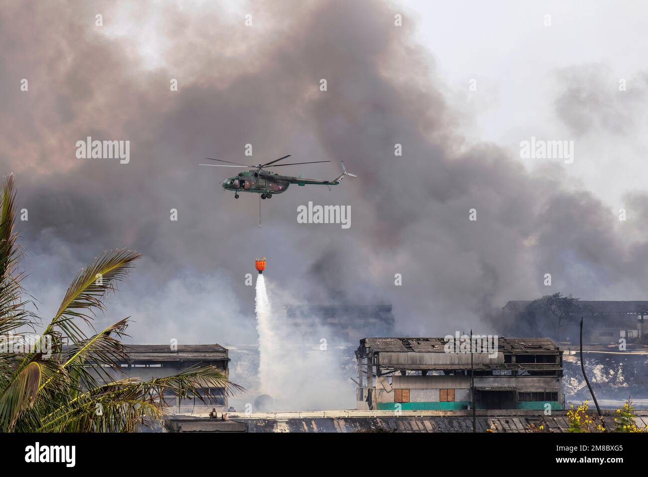 Cuban armed forces helicopter putting out the fire from the explosion ...