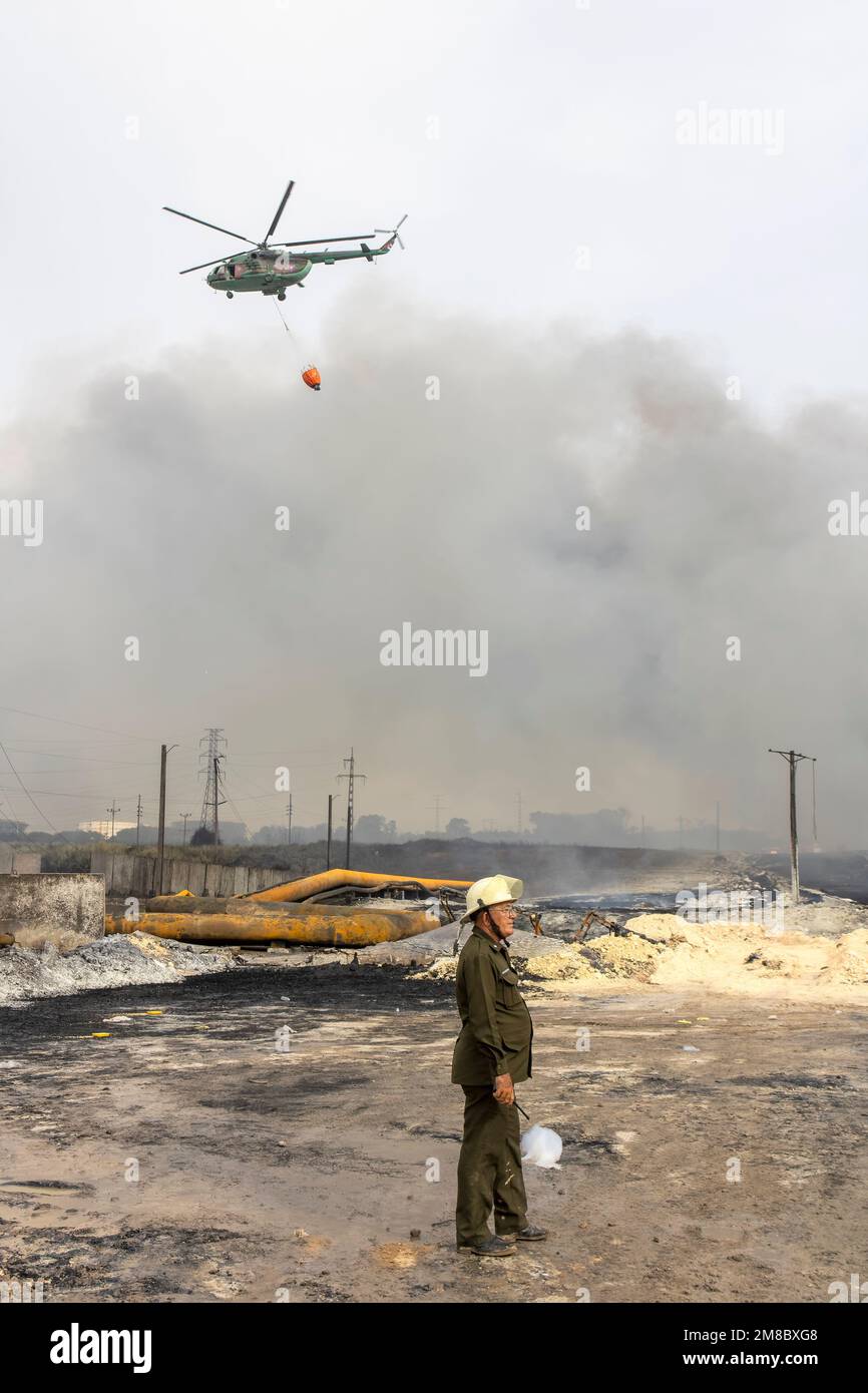 Cuban armed forces helicopter putting out the fire from the explosion ...