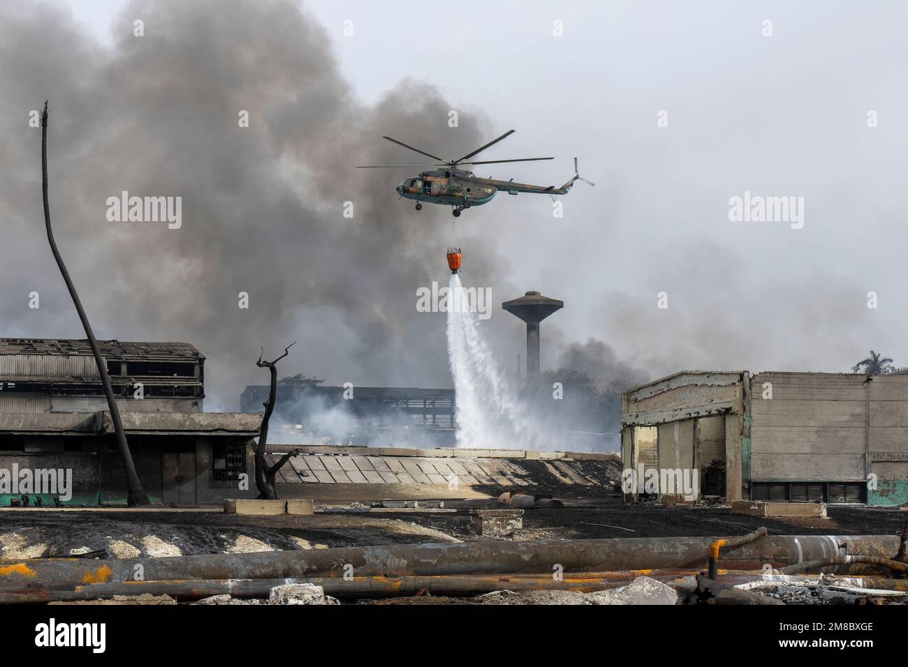 Cuban armed forces helicopter putting out the fire from the explosion ...