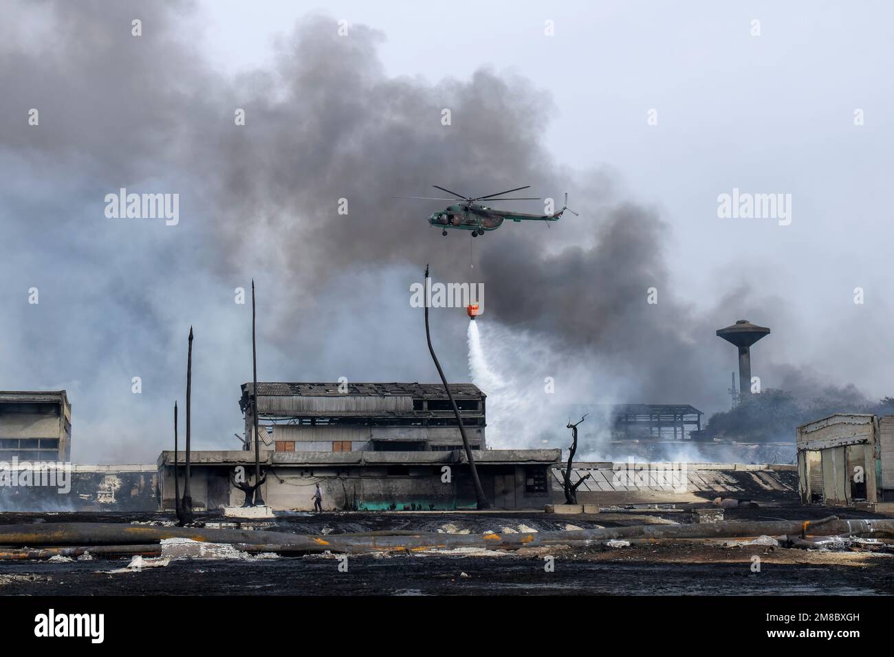 Cuban armed forces helicopter putting out the fire from the explosion ...
