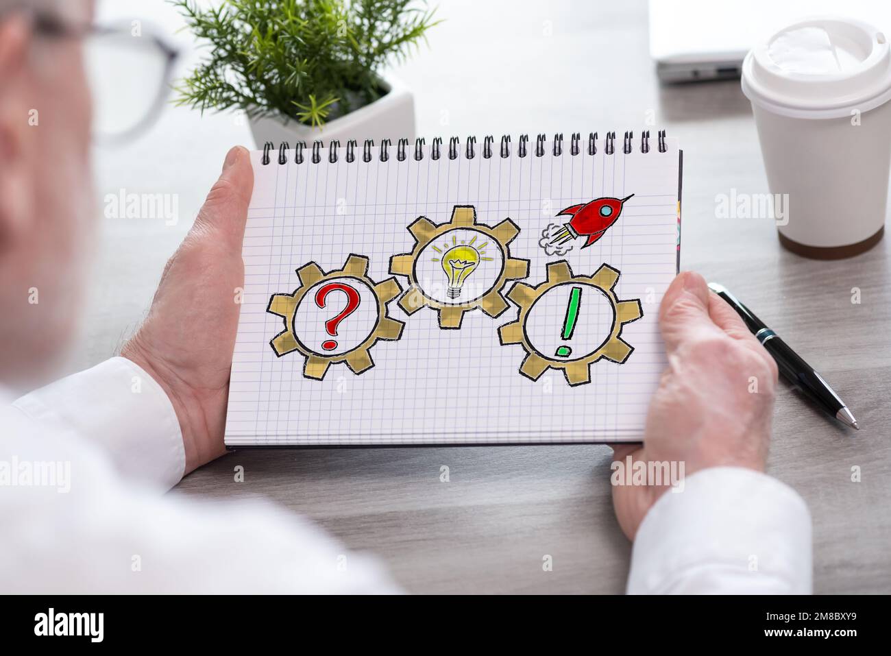 Hand holding a notepad with problem solving concept Stock Photo - Alamy