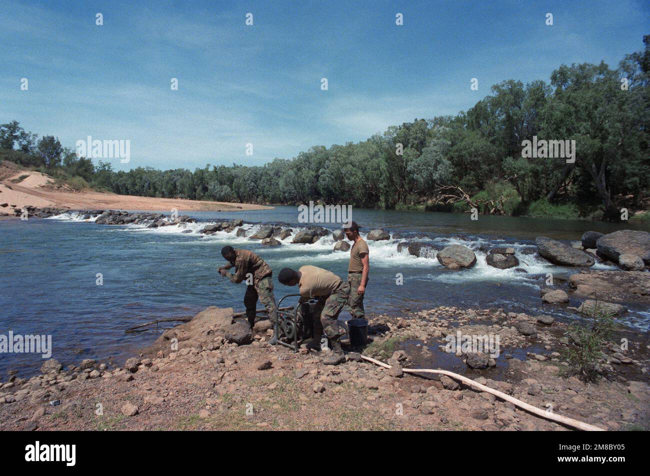 Members of the 725th Maintenance Unit set up a water purification pump ...