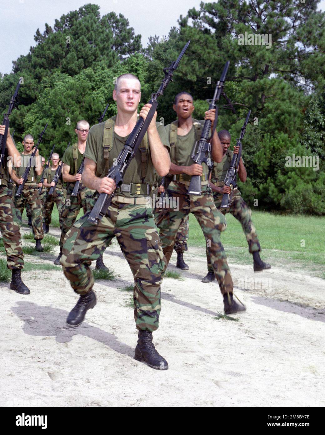 First Battalion recruits armed with bayonet-equipped M-16A2 rifles take part in a drill. Base ...