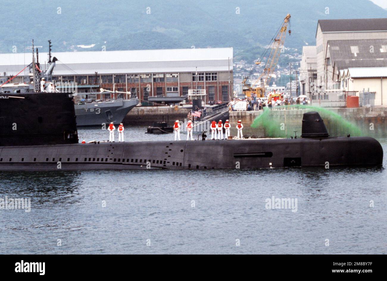 Crew members stand atop the attack submarine USS DARTER (SS 576) as the ...
