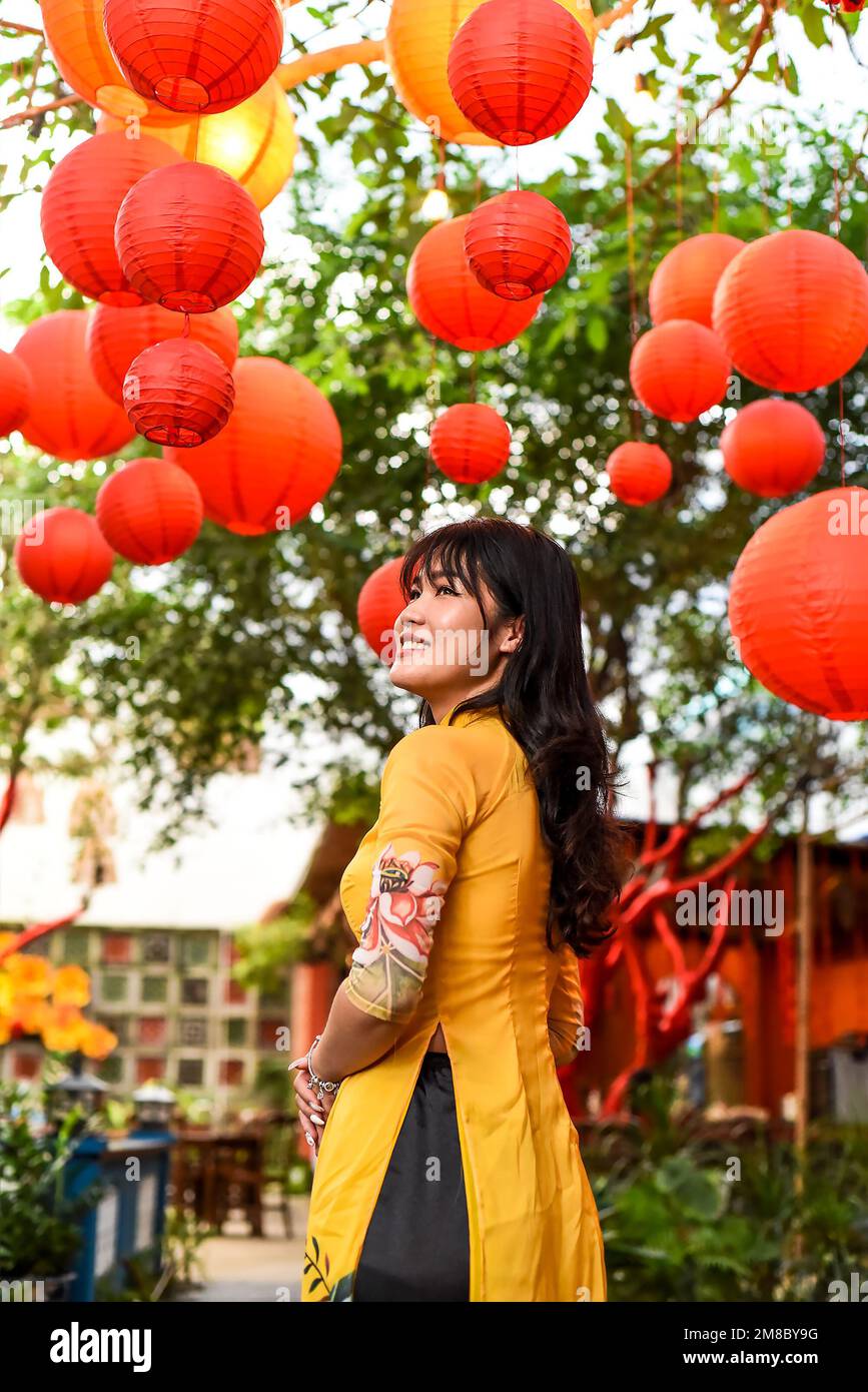 Beautiful Vietnamese woman in traditional vietnamese dress near red ...