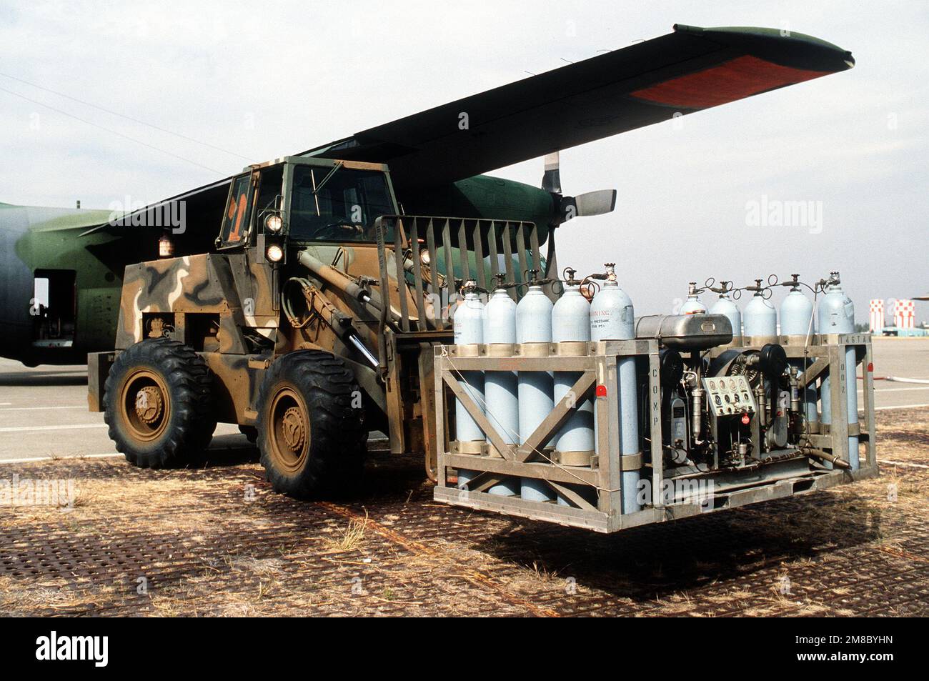 An MW20BFL rough terrain forklift is used to move an air compressor ...