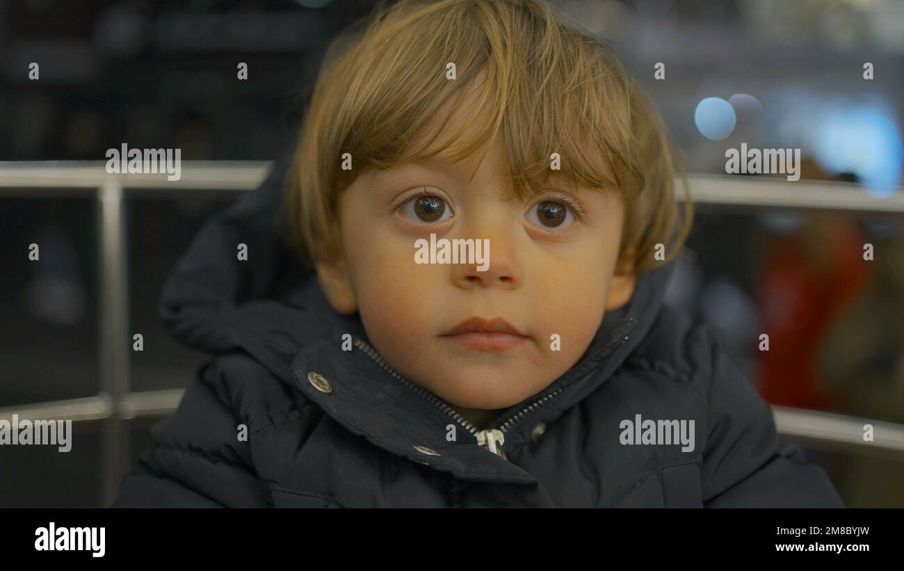 Child boy waiting for carousel to start sitting patiently Stock Photo ...