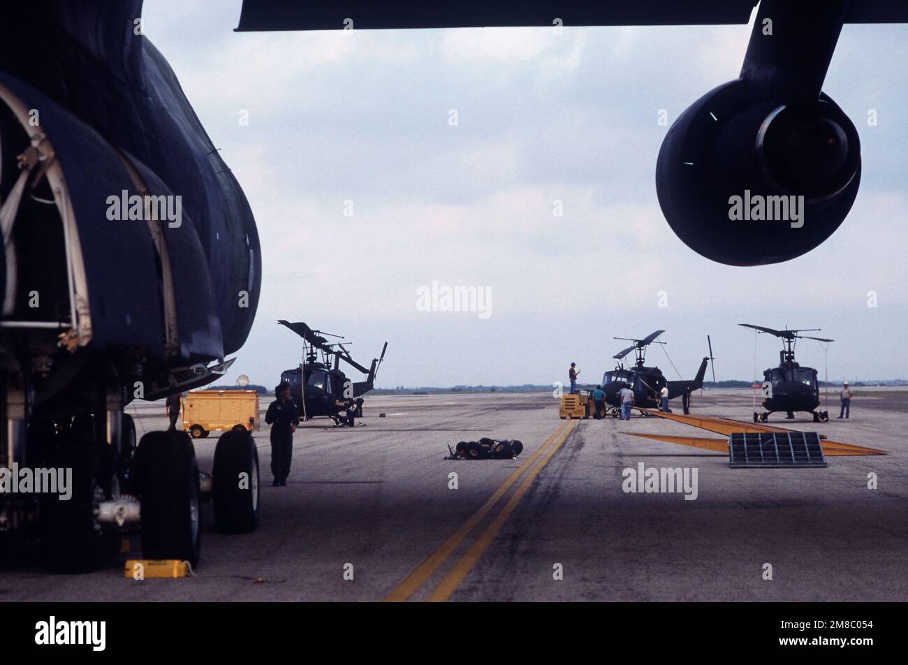 Civilian workers and U.S. military personnel prepare UH-1 Iroquois ...