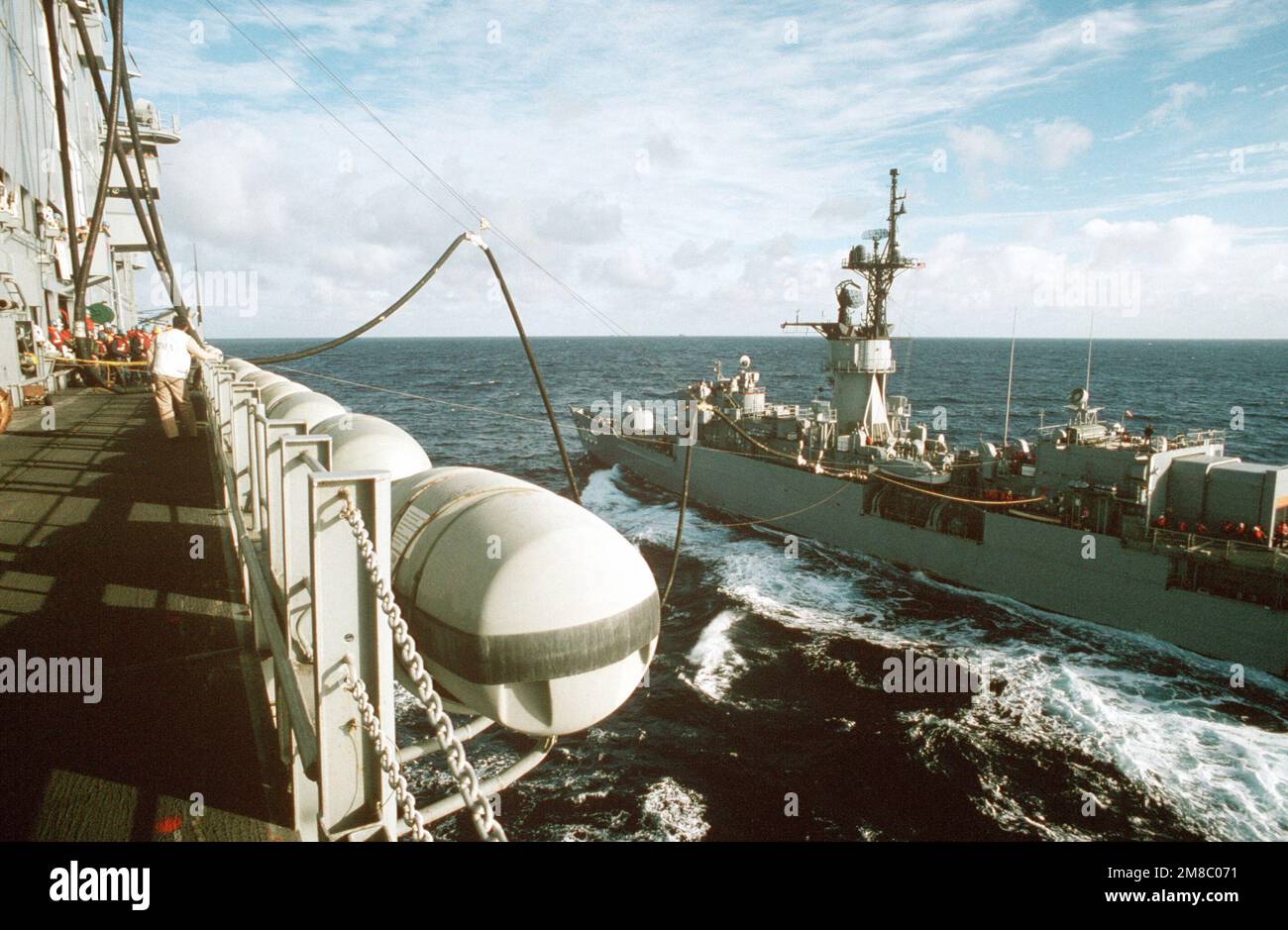 The frigate USS LANG (FF 1060) is replenished underway by the ...