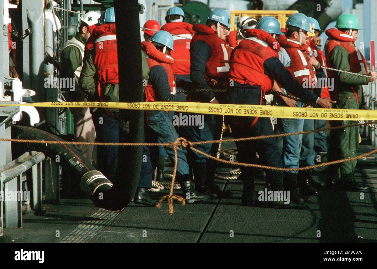 Crew members aboard the frigate USS LANG (FF 1060) set up a manila rig ...