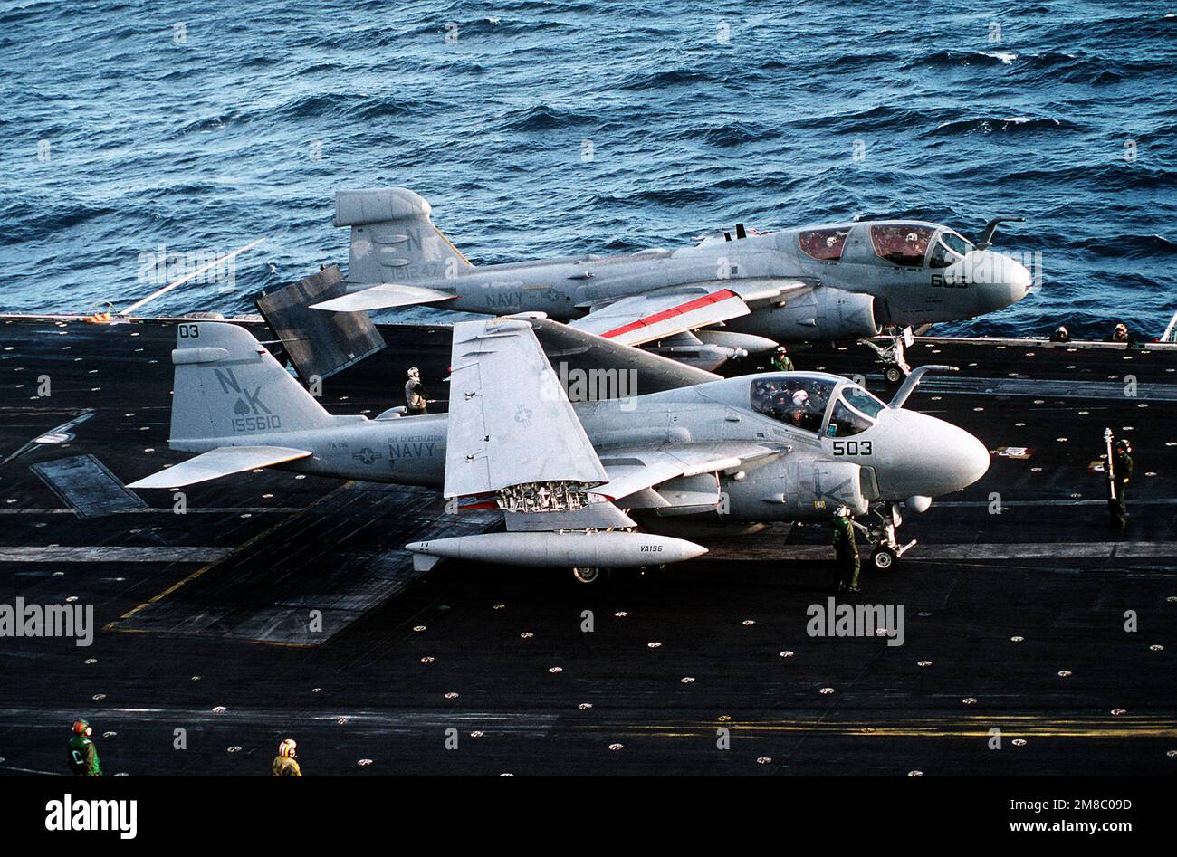 An Attack Squadron 196 (VA-196) A-6E Intruder aircraft stands by as an ...