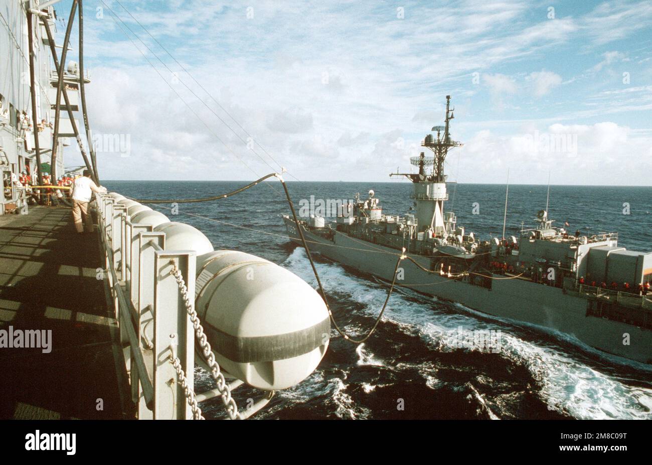 The frigate USS LANG (FF 1060) is replenished underway by the ...