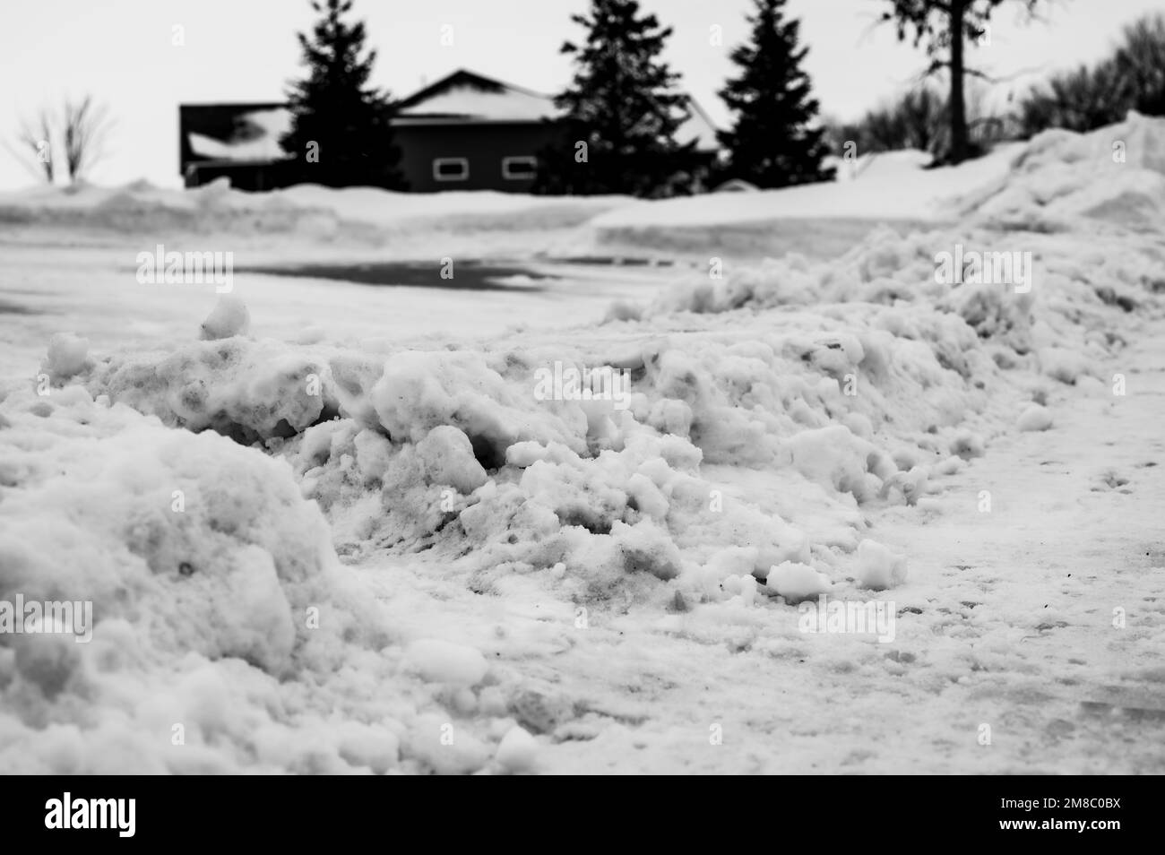 Snowbank at the end of a driveway left after city snowplows cleared a ...