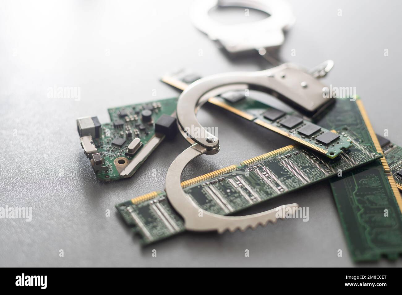 Digital security concept: handcuffs on the background of a computer ...