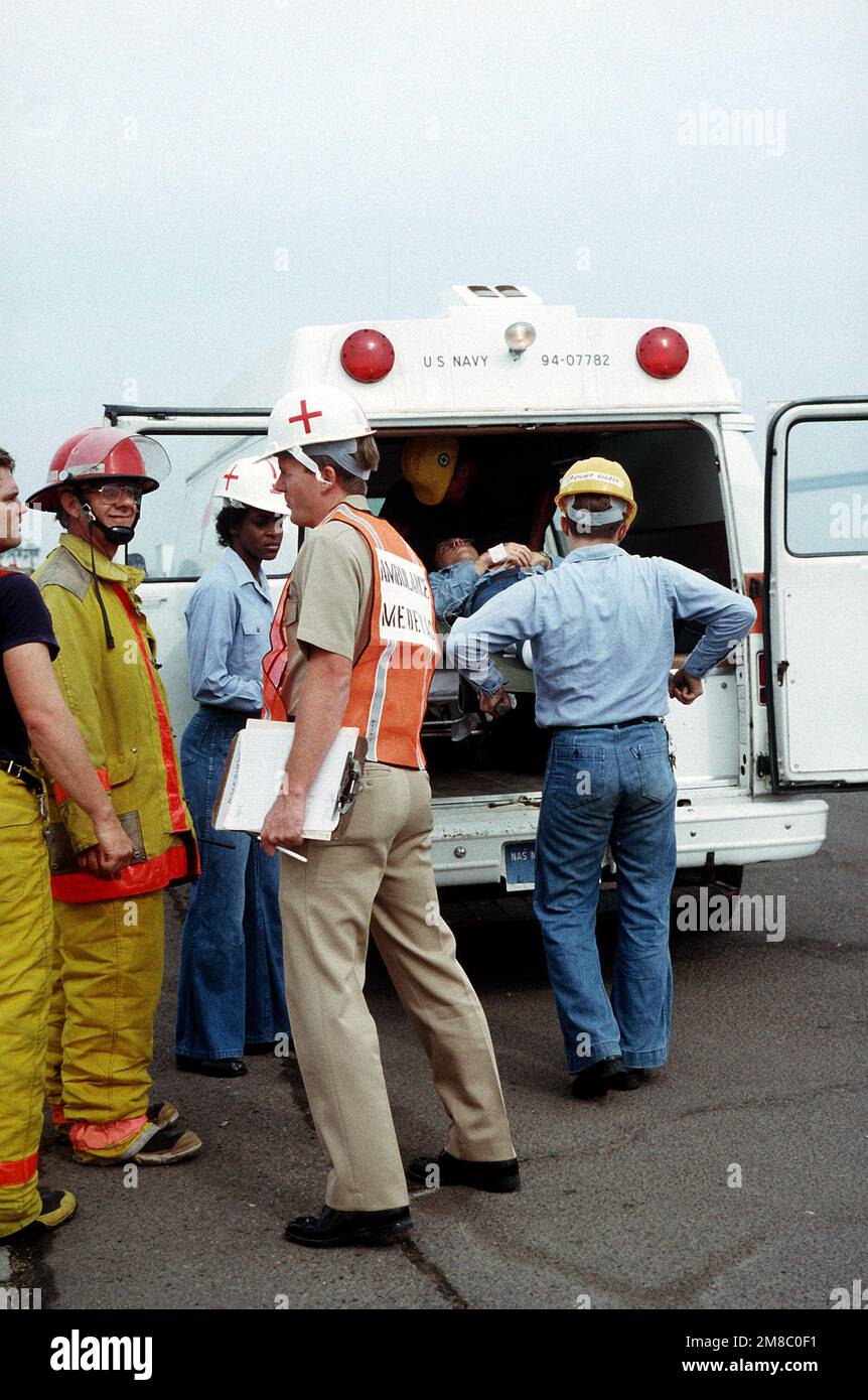 Members of a medical evacuation team load a patient into a Naval Air ...
