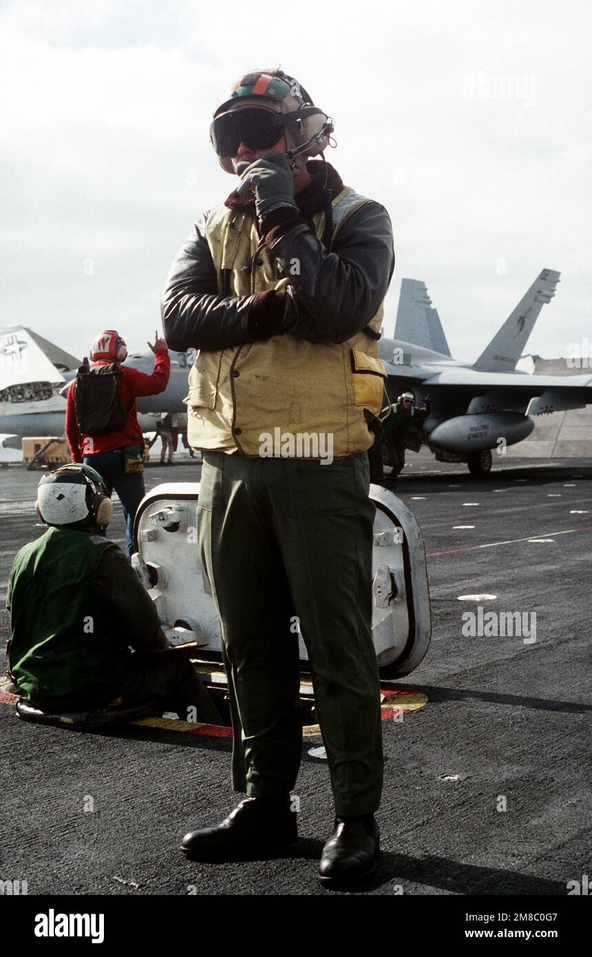A catapult officer stands by on the flight deck of the aircraft carrier ...