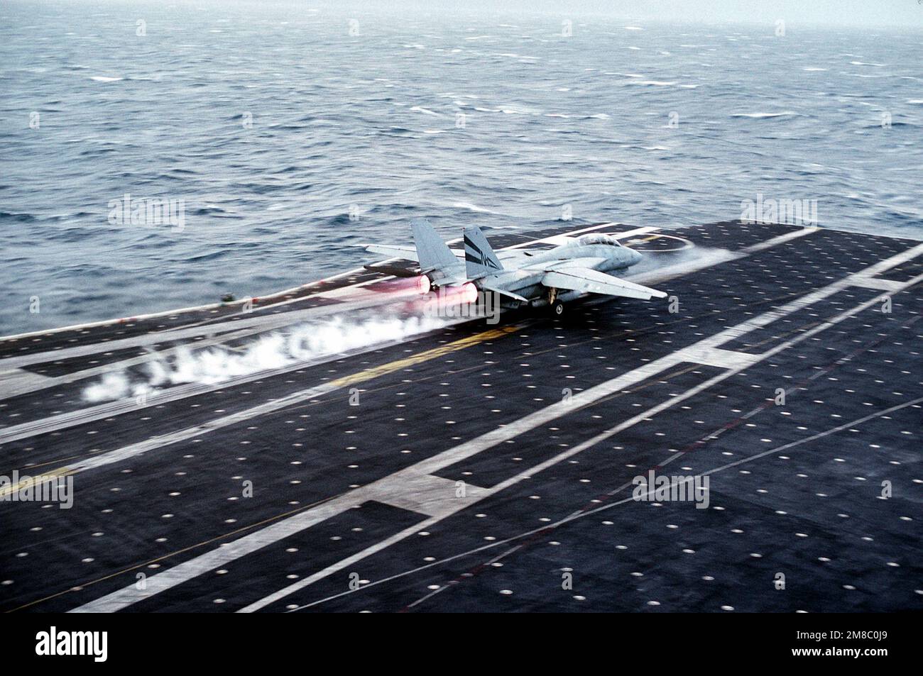 An F-14A Tomcat aircraft of Fighter Squadron 154 (VF-154) approaches ...