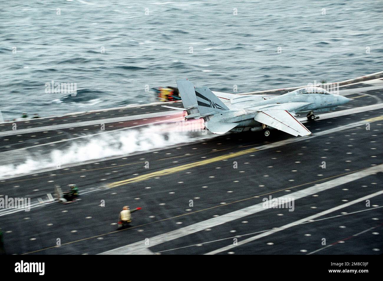 An F-14A Tomcat aircraft of Fighter Squadron 154 (VF-154) roars past ...