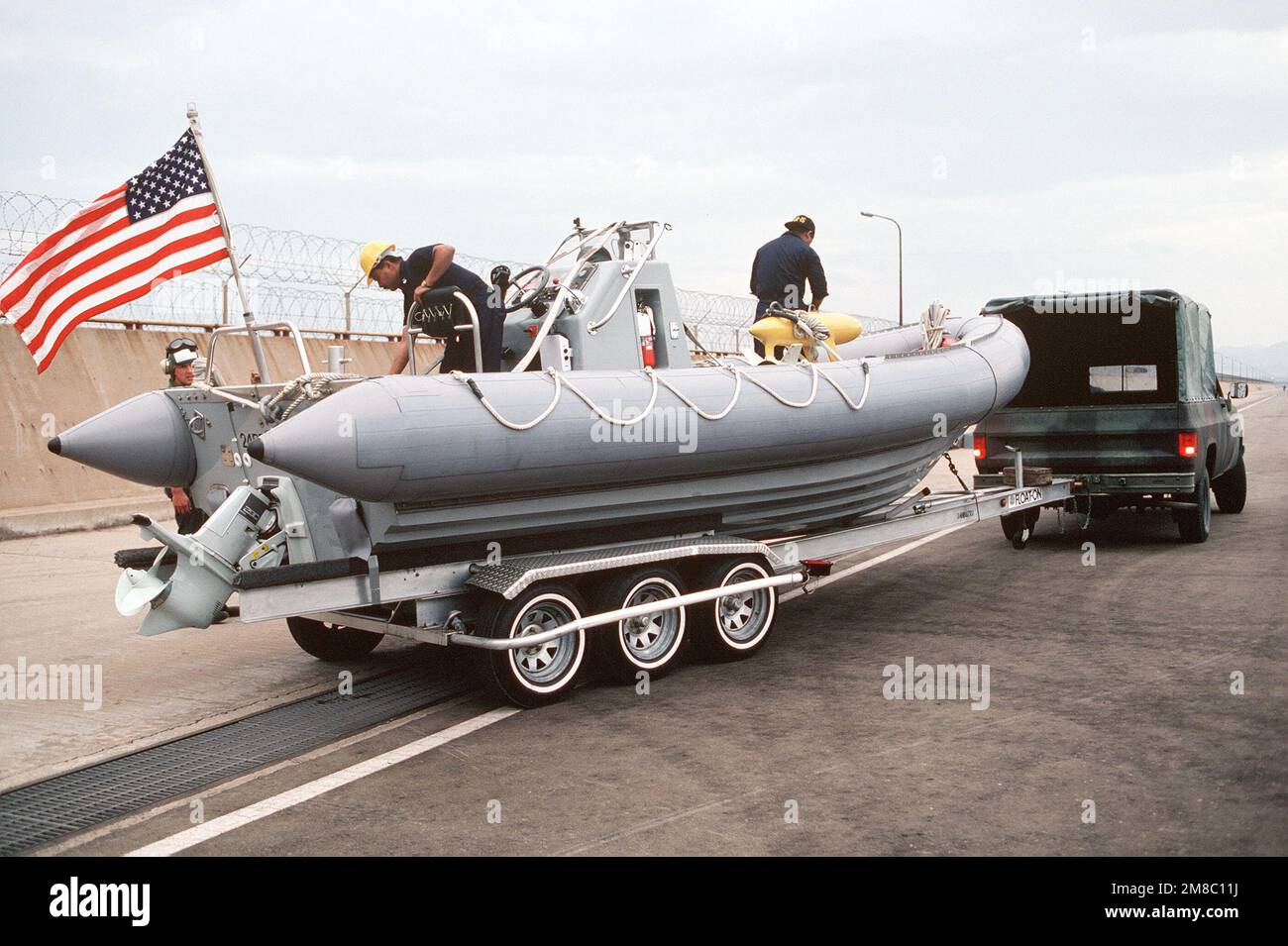 A motorized raft which will be used to support a mine sled is towed to ...