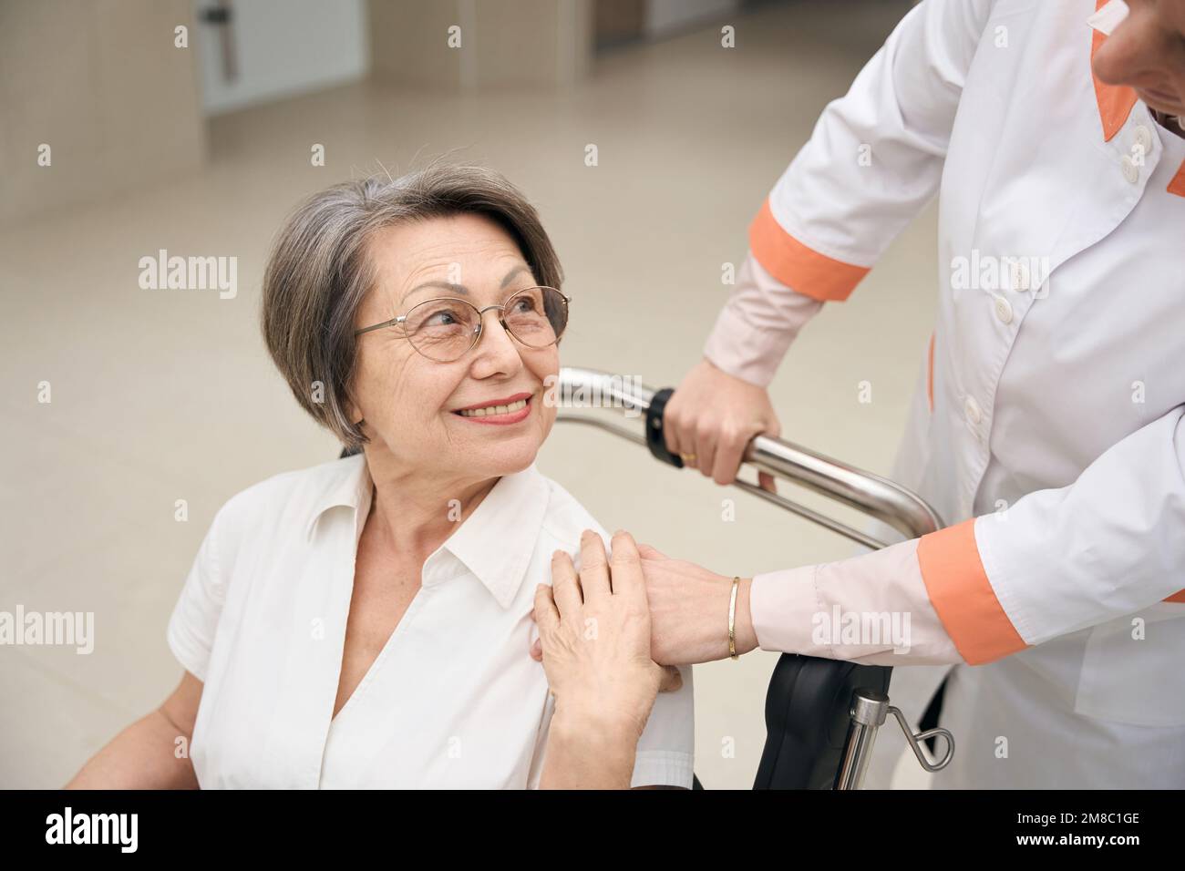 Woman with a disability moves in a wheelchair Stock Photo - Alamy