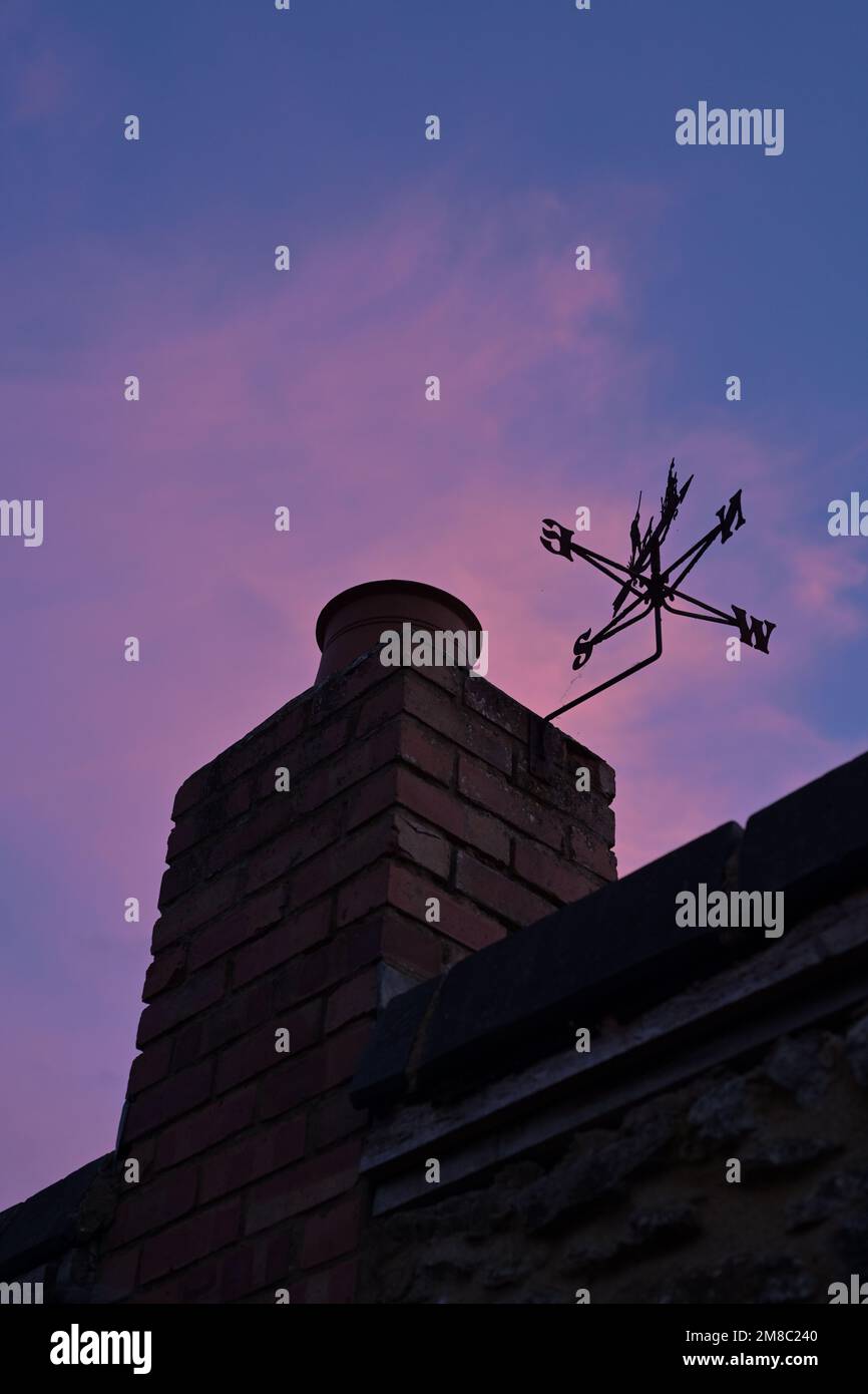 A low-angle shot of the vane showing direction on the near the chimney ...