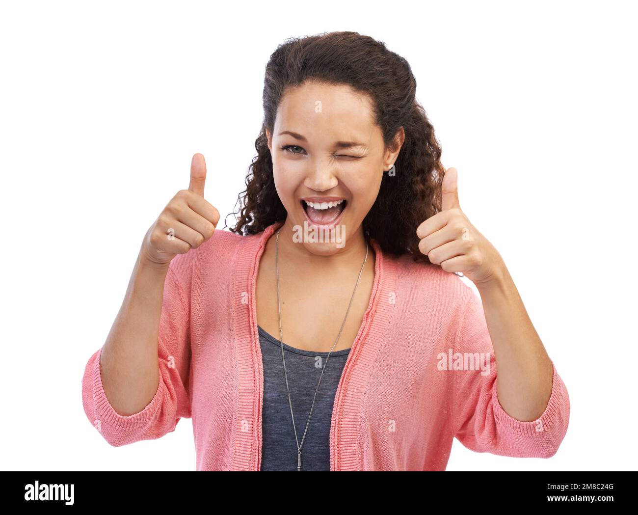 Face portrait, thumbs up and wink of woman in studio isolated on a ...