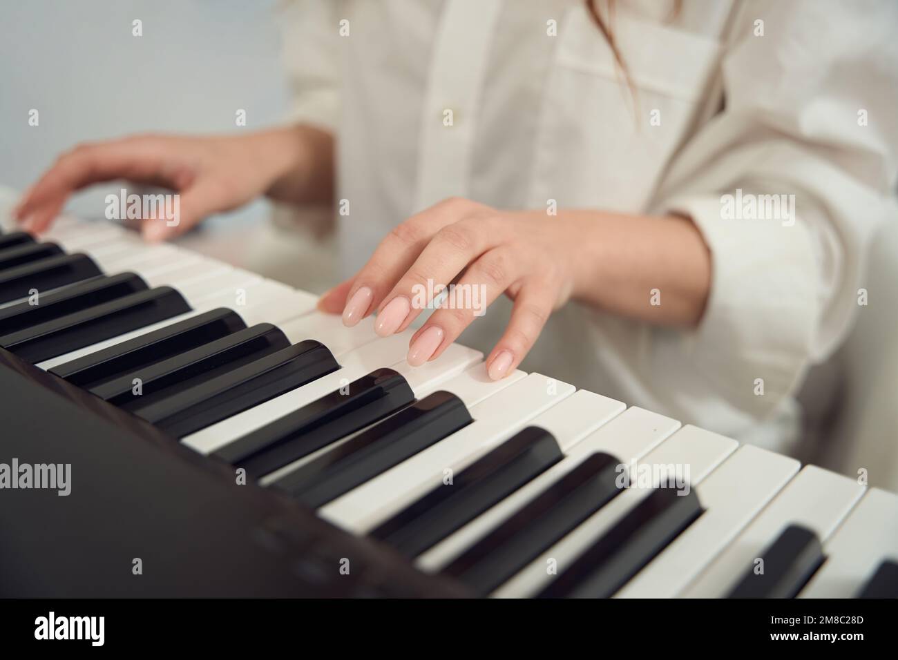 Female composer composing new tune on her synthesizer Stock Photo - Alamy