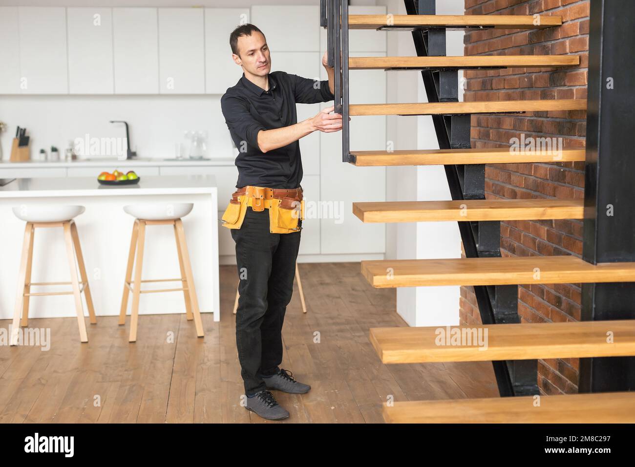 Home improvement handyman building staircase in a natural light Stock Photo - Alamy