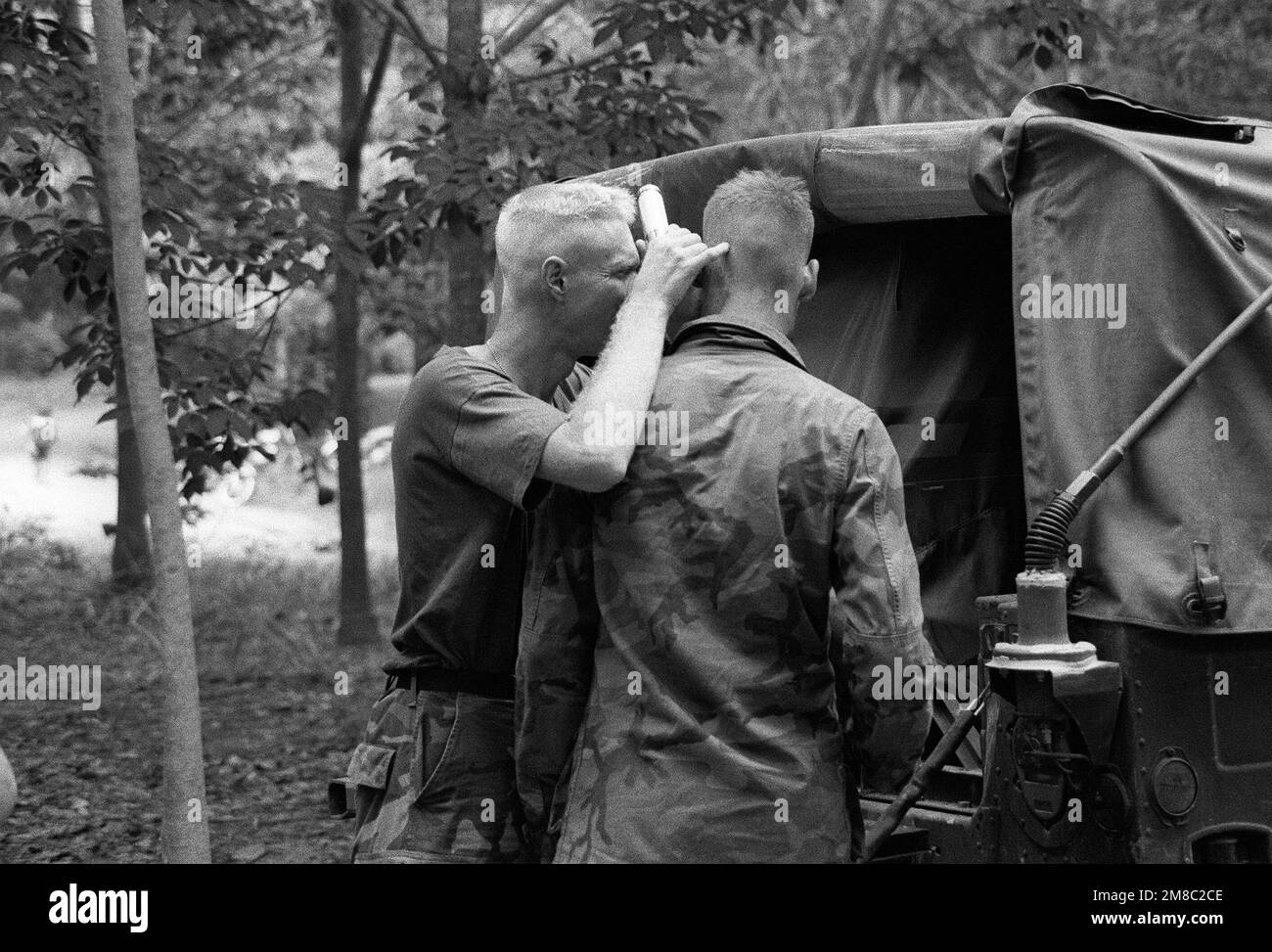 A Navy corpsman examines a Marine's ear at an aid station during the ...